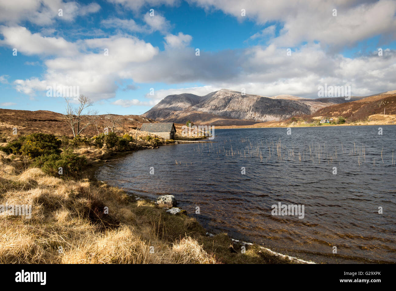 View of a boathouse on Loch Stack, with Ben Arkle in the background ...