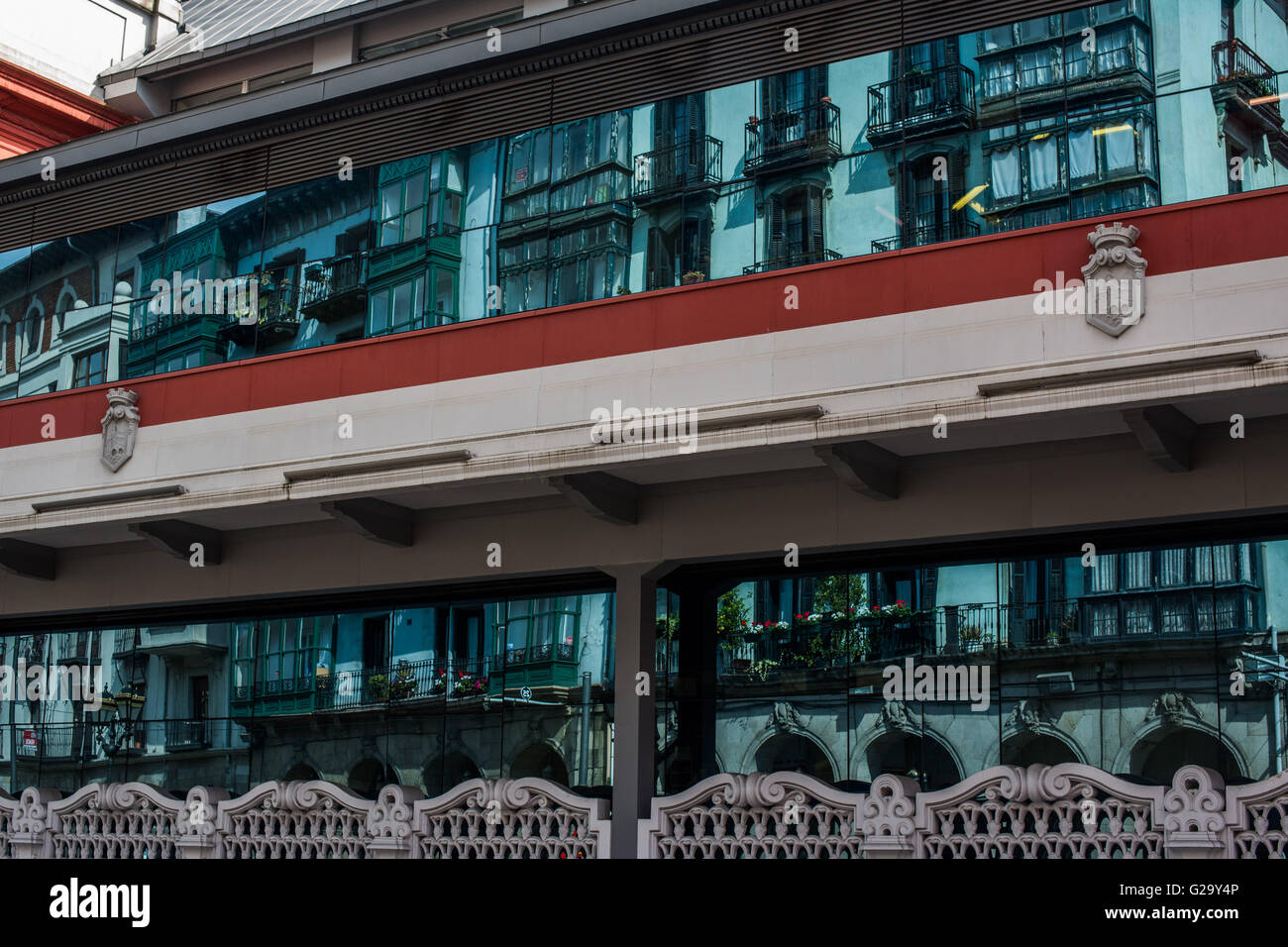 Old green building reflected in the windows of the more modern ...