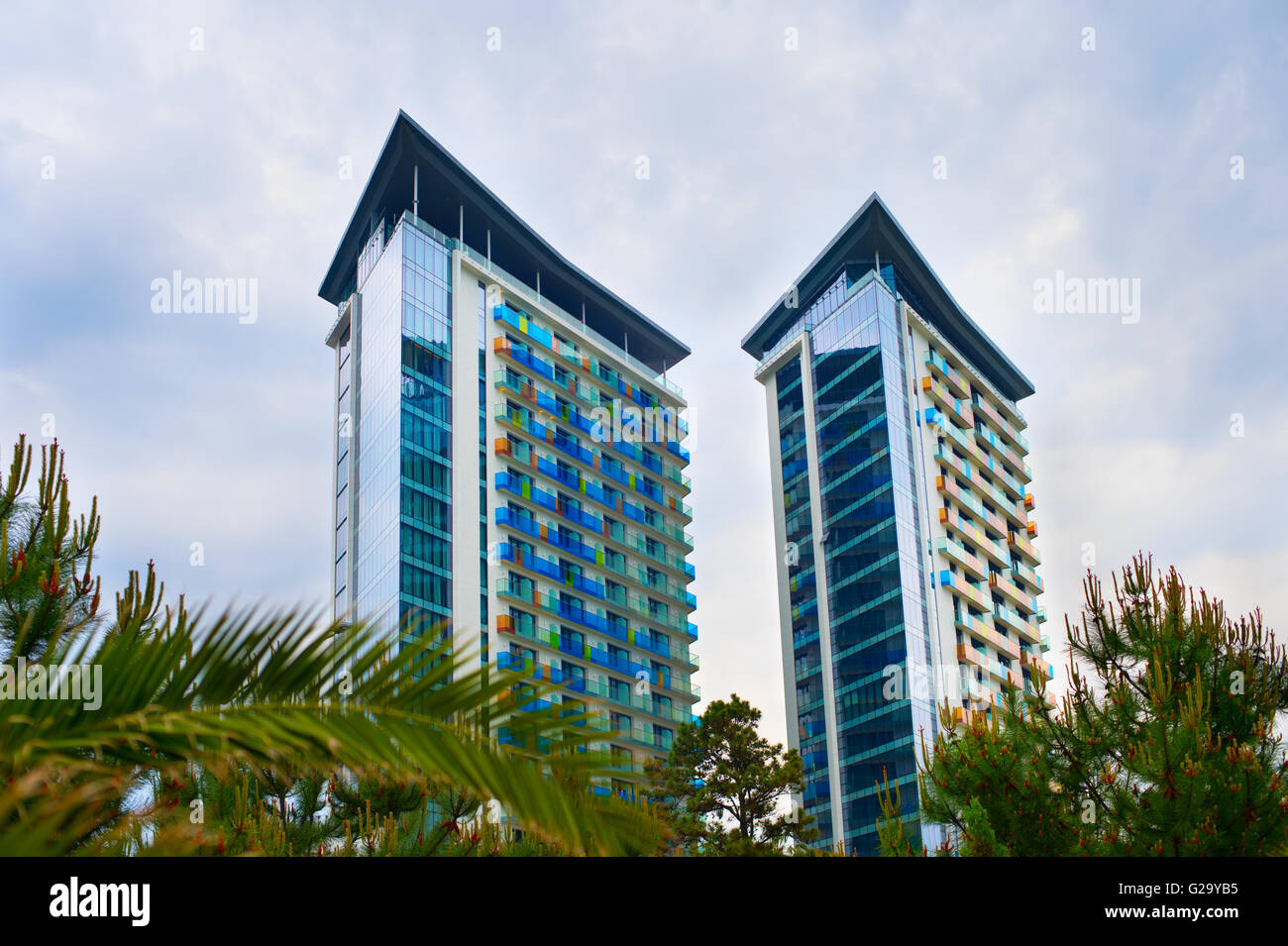Modern apartment building with trees on foreground Stock Photo - Alamy