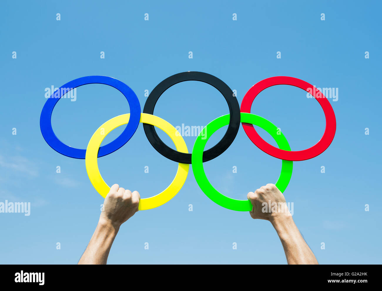 RIO DE JANEIRO - MARCH 15, 2016: Hands of athlete hold Olympic rings ...