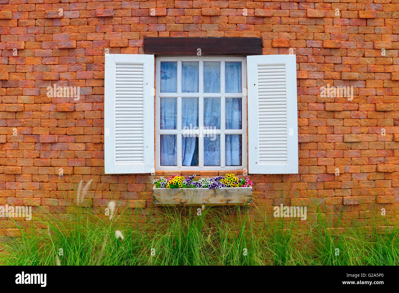 White window on red brick wall of vintage house style Stock Photo - Alamy