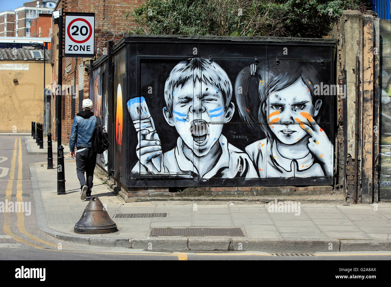 A pedestrian looks at a mural painted in Hackney Street, London Stock ...