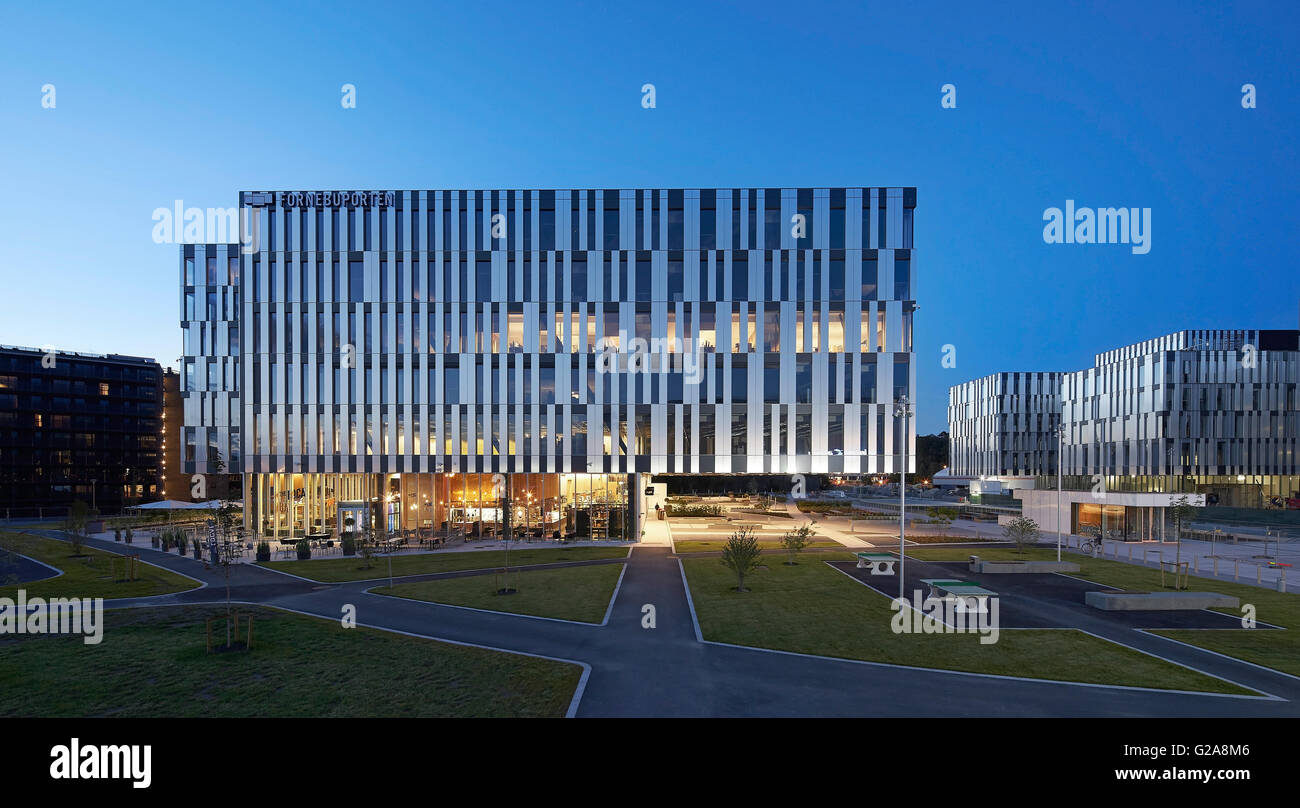 Elevated view across landscaped square and illuminated building complex ...