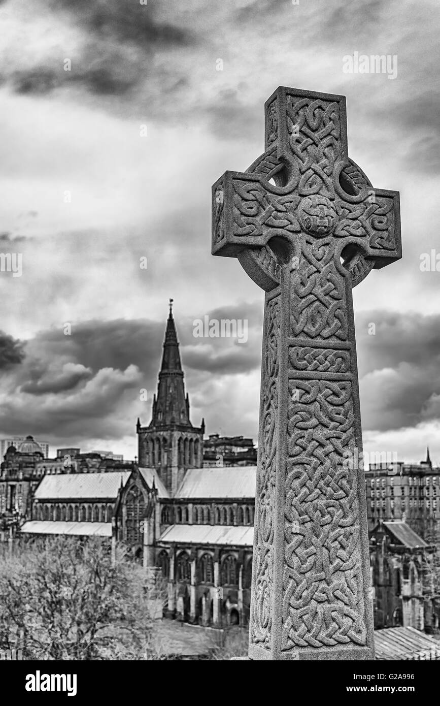 A monochromatic image of a celtic cross headstone situated at the ...