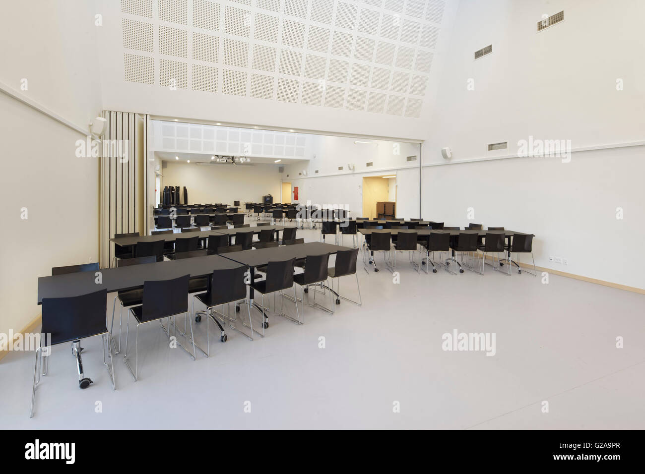 Community centre meeting area with open room divider and black seating ...
