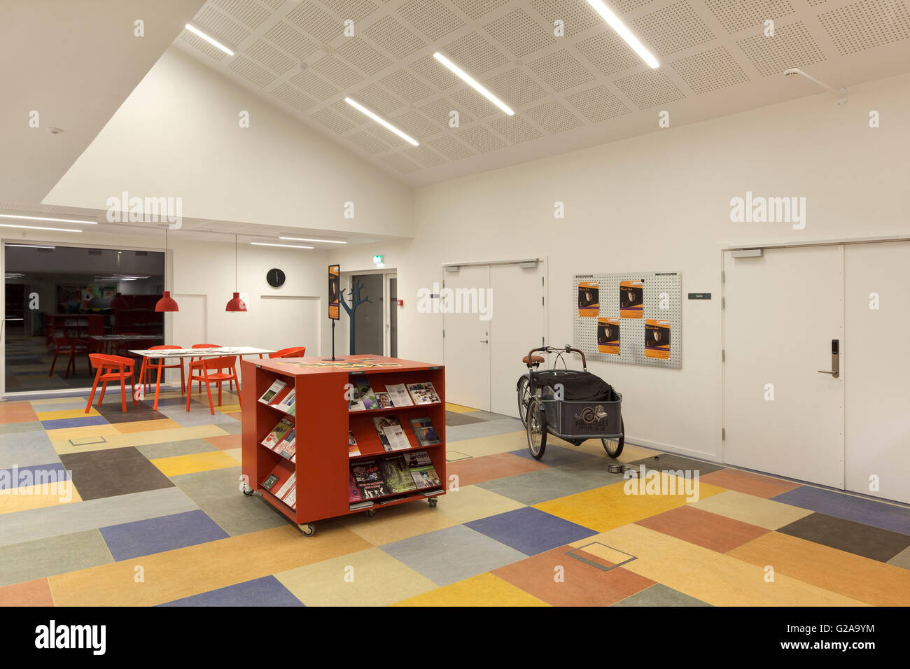 Periodical reading area with coloured chequered flooring and orange ...