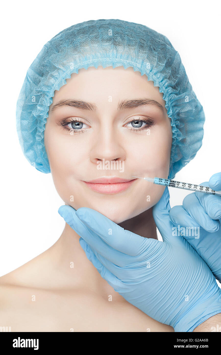 Attractive woman at plastic surgery with syringe in her face Stock ...