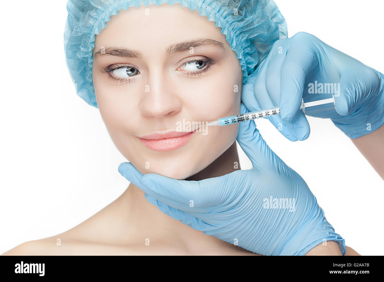 Attractive woman at plastic surgery with syringe in her face Stock ...