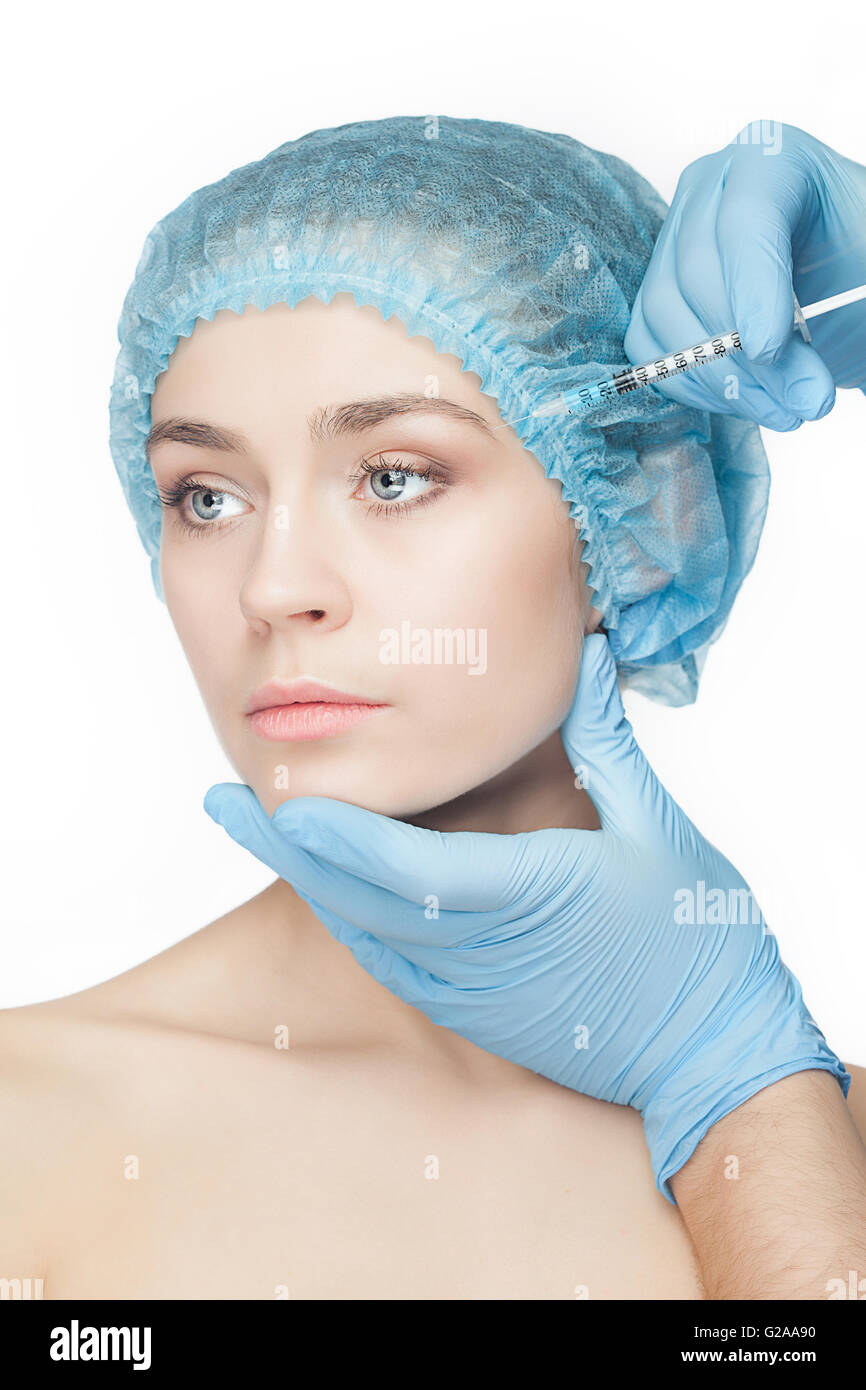 Attractive woman at plastic surgery with syringe in her face Stock ...