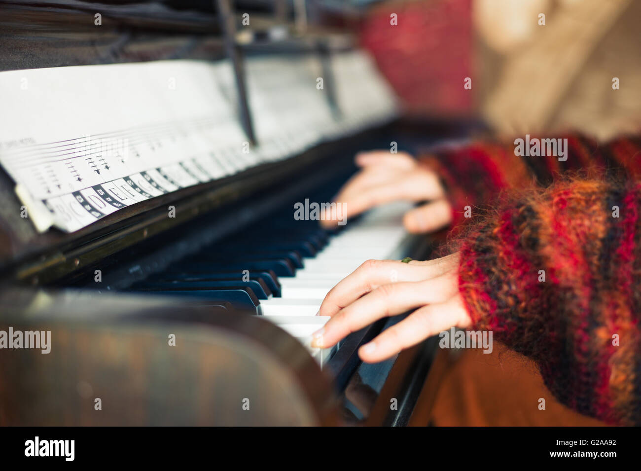 The hands of a young woman as she is playing the piano Stock Photo - Alamy
