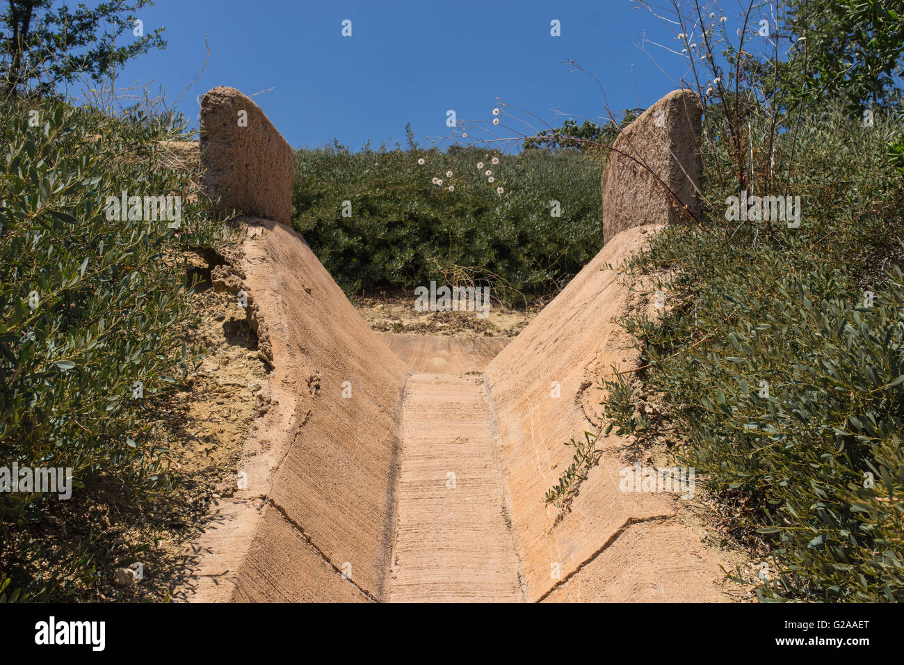 Top of a drainage ditch culvert for running water opens on hillside ...