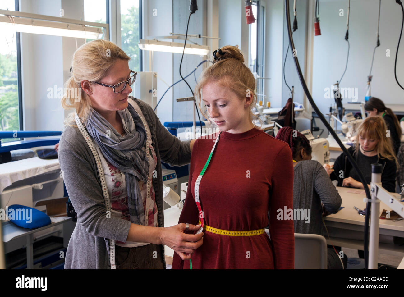 Fitting during the practical training for tailors Stock Photo - Alamy