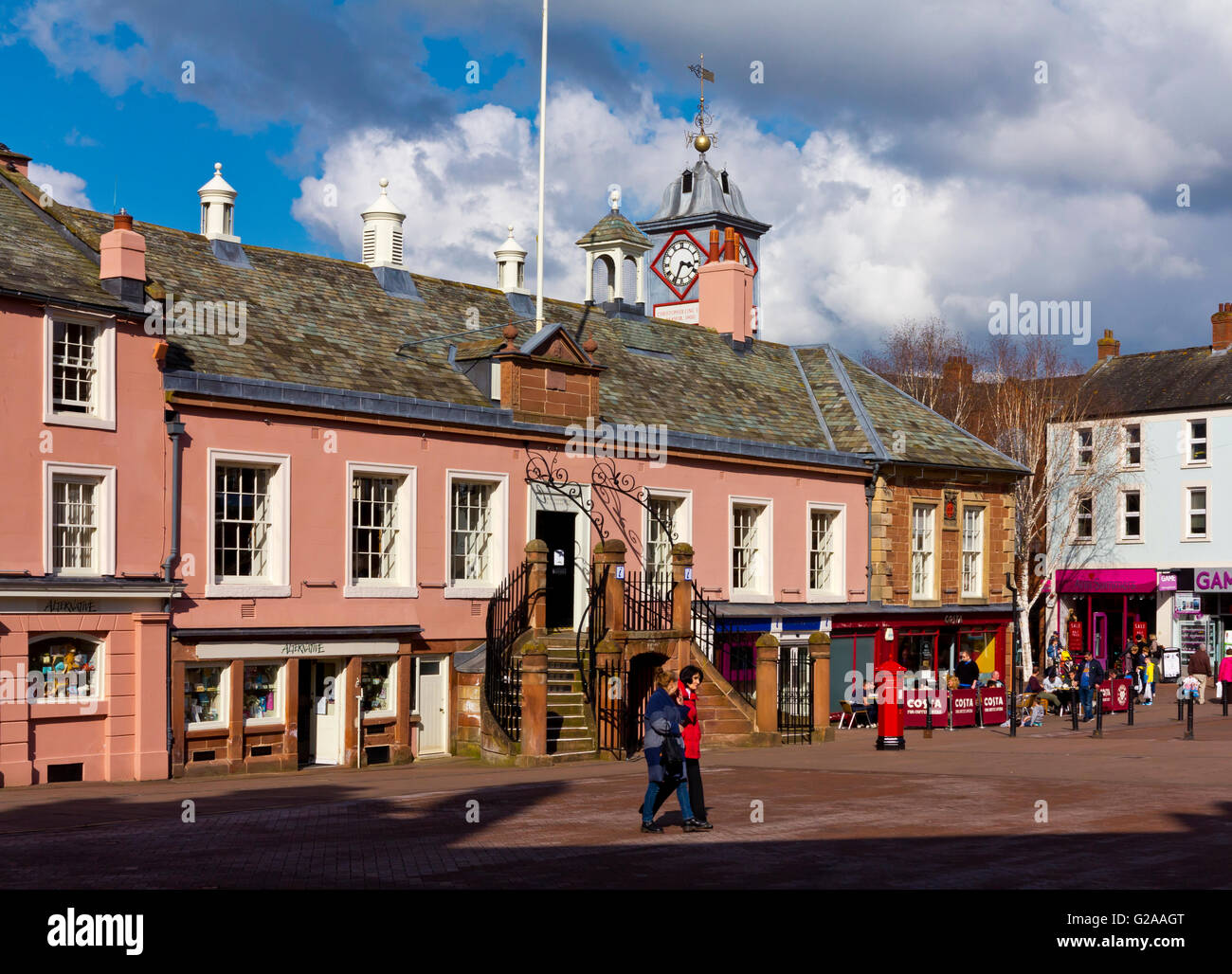 Shoppers walking past the Tourist Information Centre in Carlisle city ...