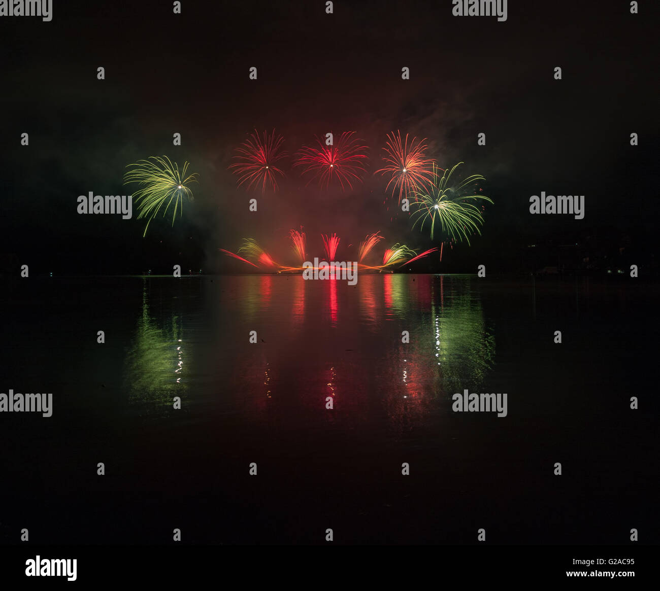 Colorful fireworks with reflection on lake and night sky in background ...