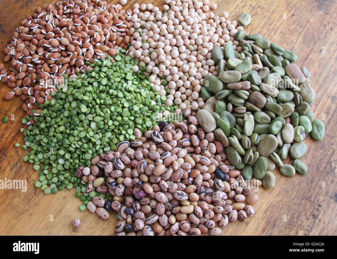 Piles of dried beans and peas on a rustic wooden table top Stock Photo ...