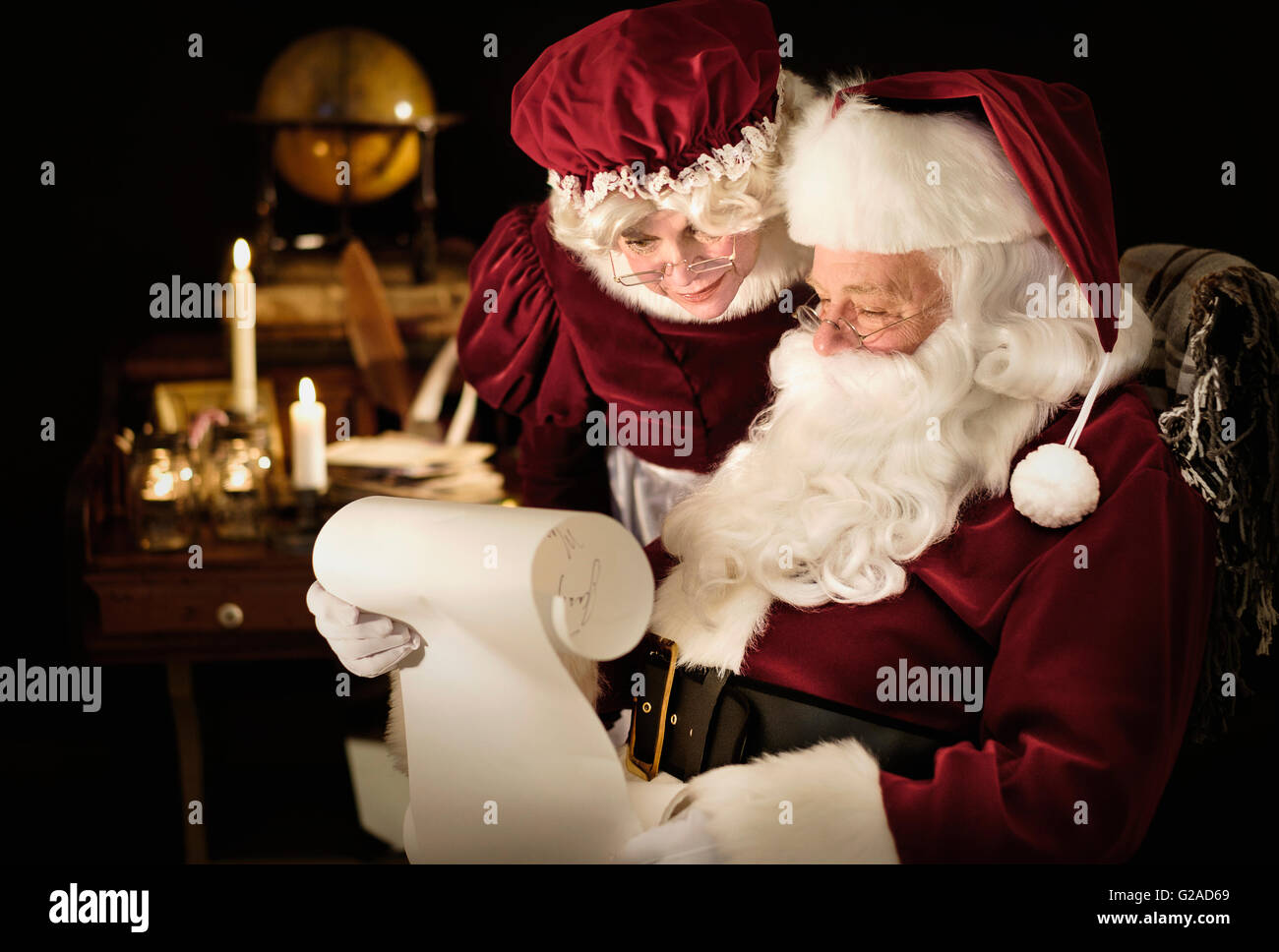 Santa and Mrs. Claus reading child's letter Stock Photo - Alamy