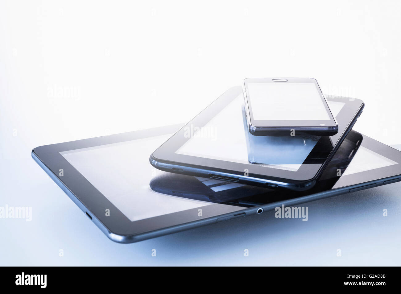 Smart phone lying on digital tablets Stock Photo - Alamy