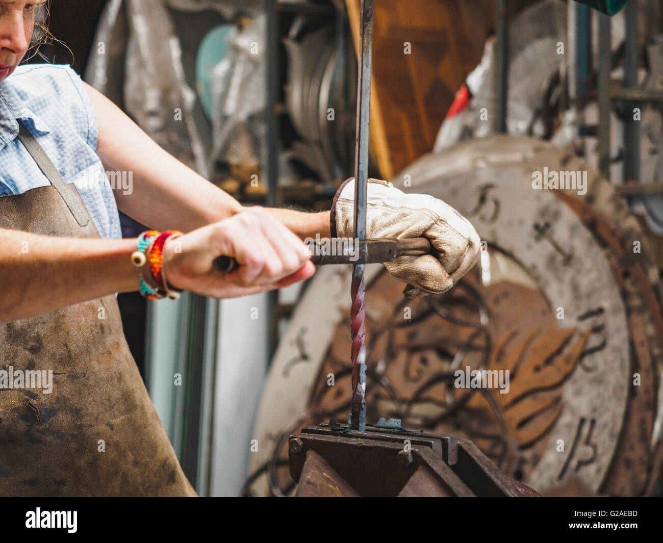 Female blacksmith working in workshop Stock Photo - Alamy