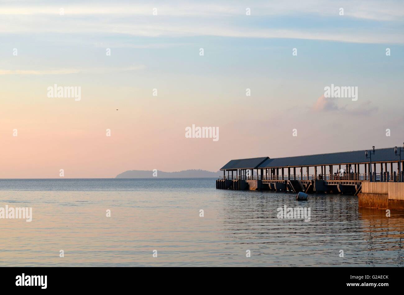 Kampong Tekek covered boat jetty in evening at Pulau Tioman resort ...