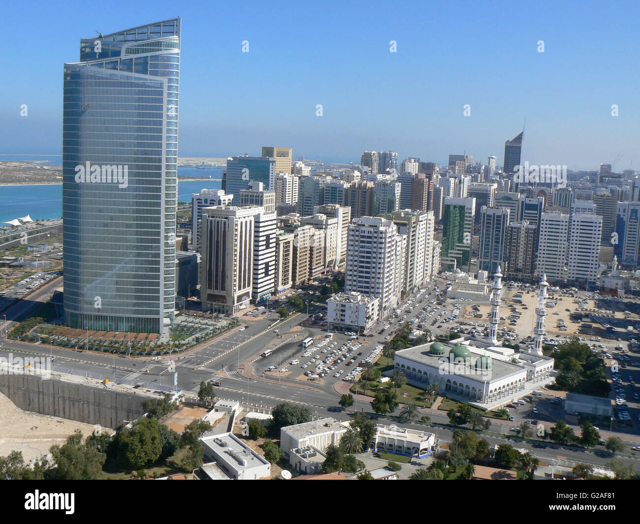 Modern high rise buildings and old mosques together in the Middle ...