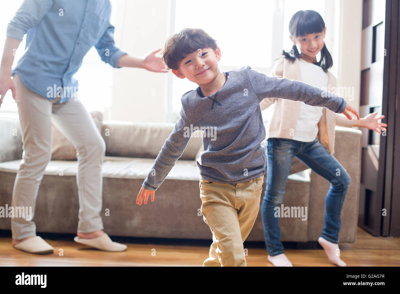 Happy young family dancing together Stock Photo - Alamy