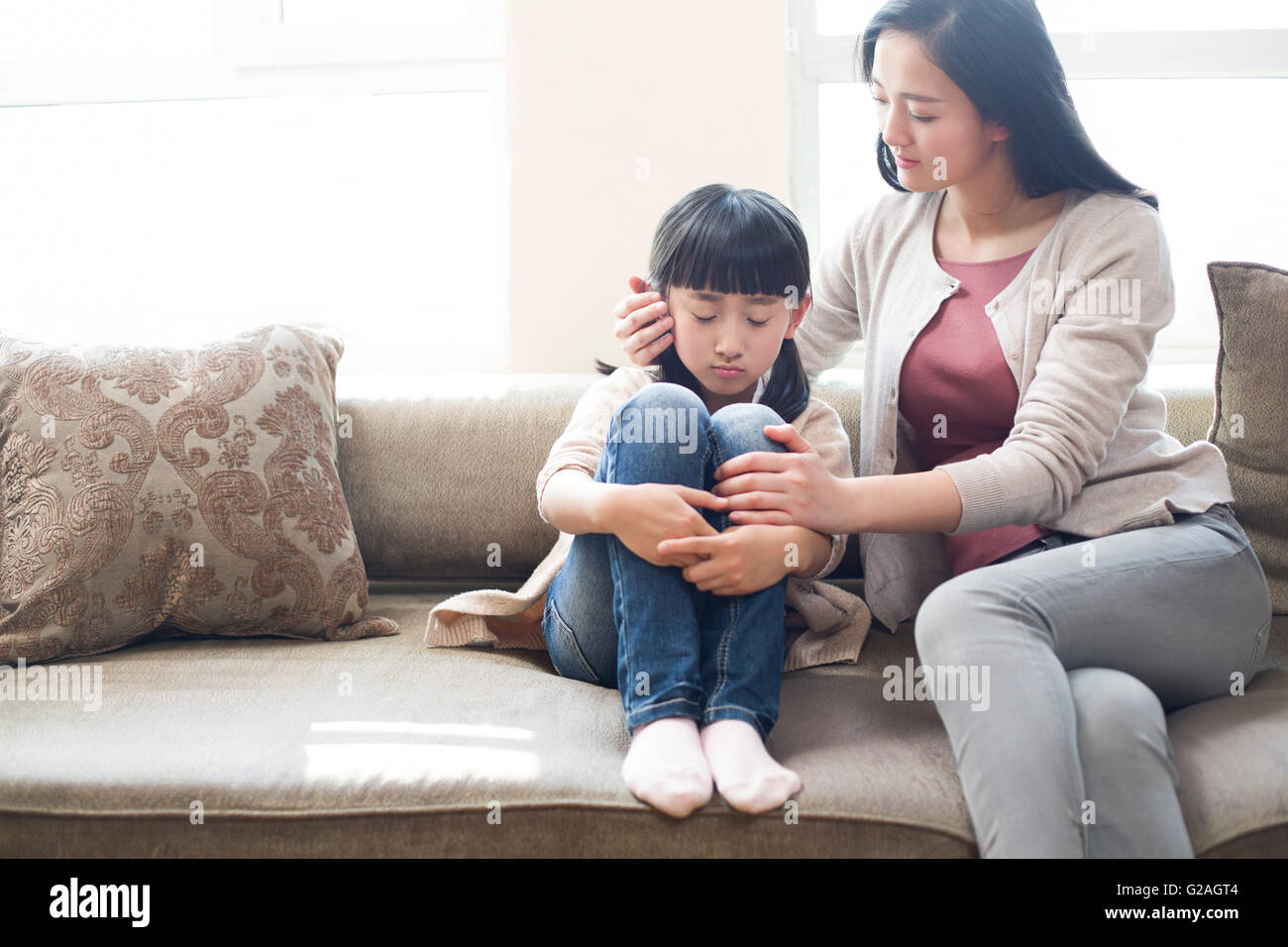 Young mother consoling her daughter Stock Photo - Alamy