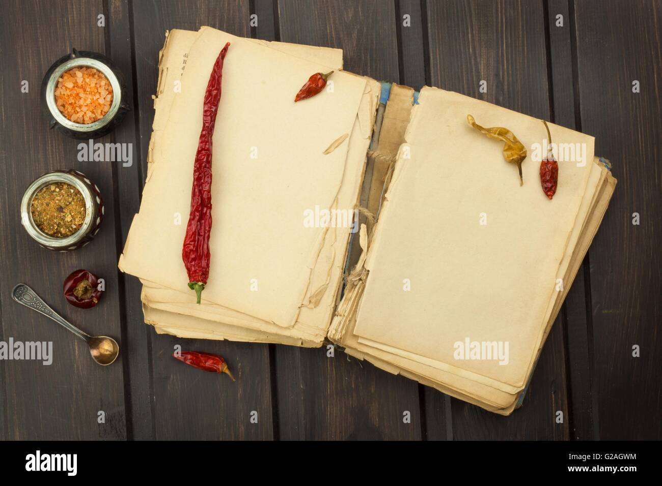 Recipe book and vegetables. Chili pepper and tomatoes. Food preparation ...