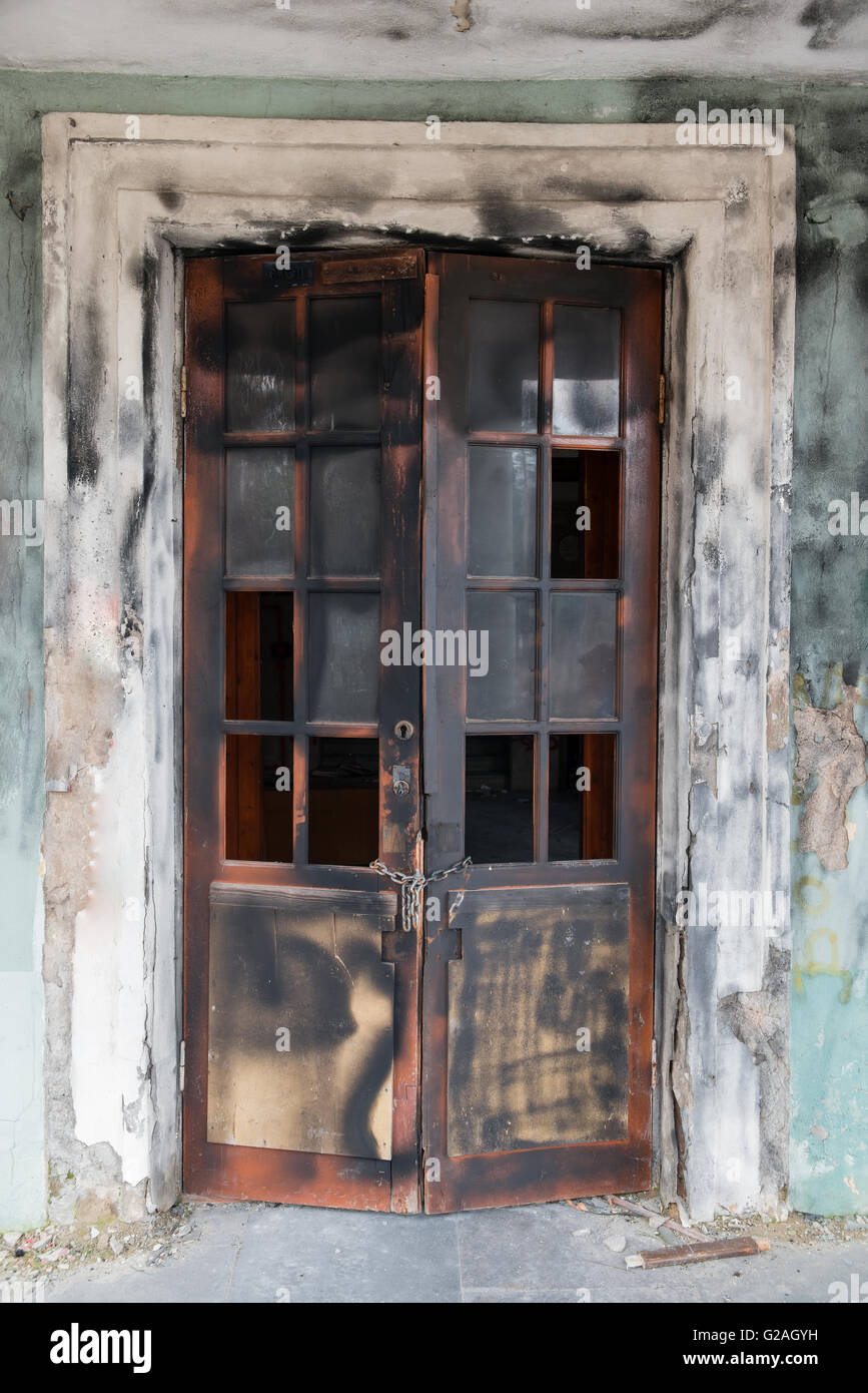 Scorched broken door of abandoned house Stock Photo - Alamy