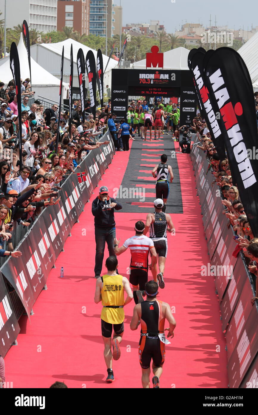 Triathletes reaching the finishing line at Ironman Barcelona 70.3 Stock ...