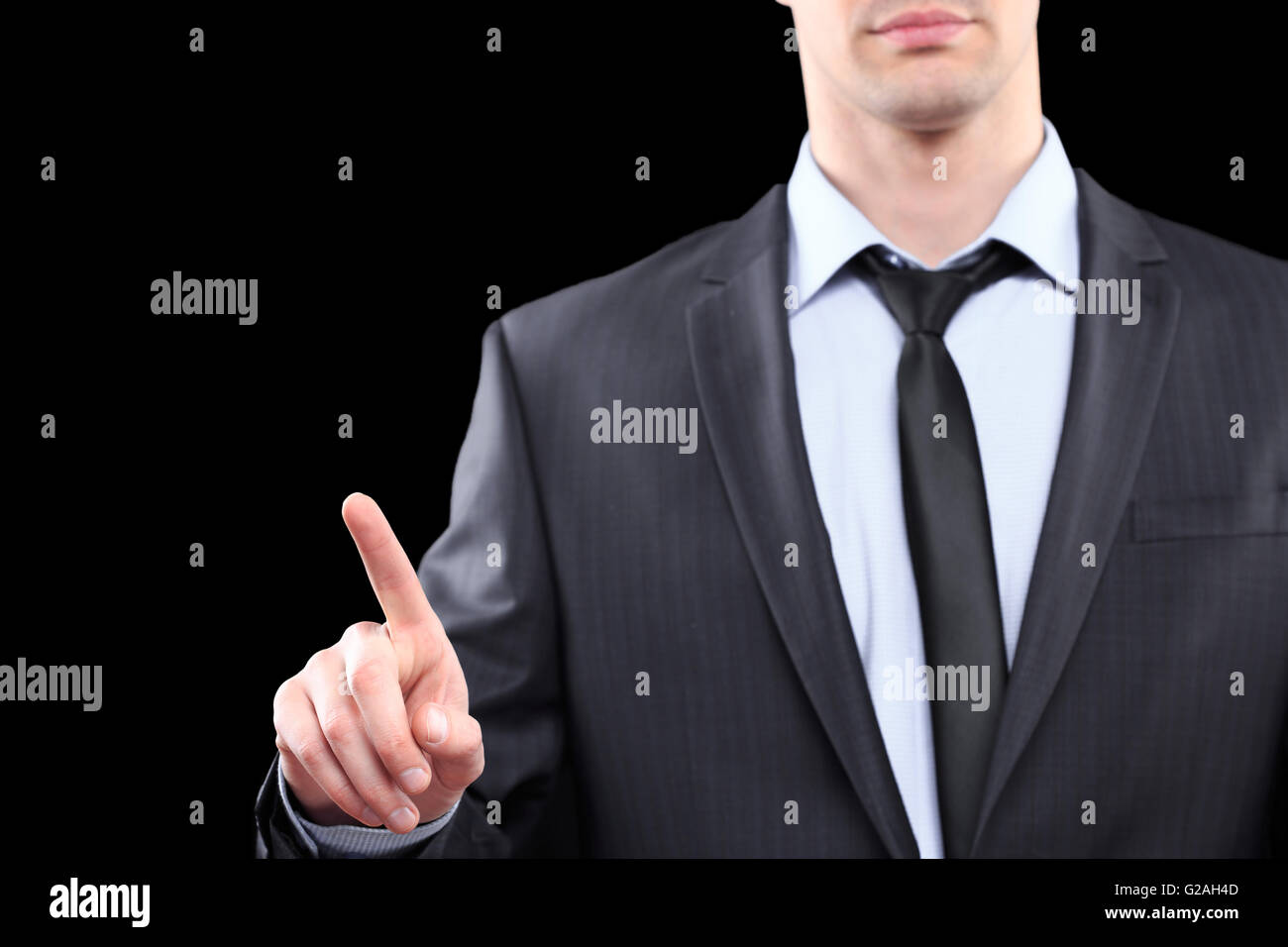 Business Man pushing on a touch screen interface. Black background ...