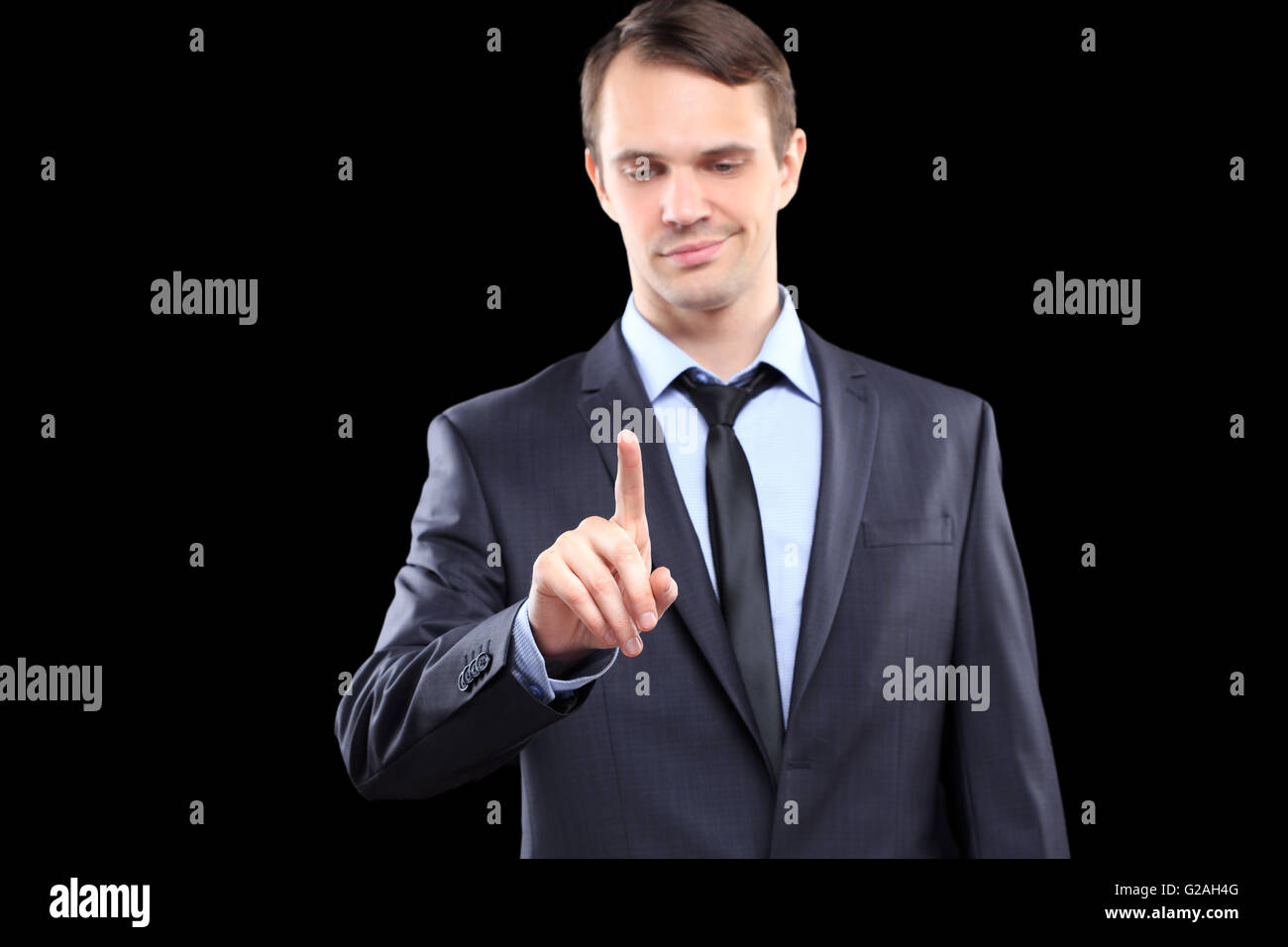 Business Man pushing on a touch screen interface. Black background ...