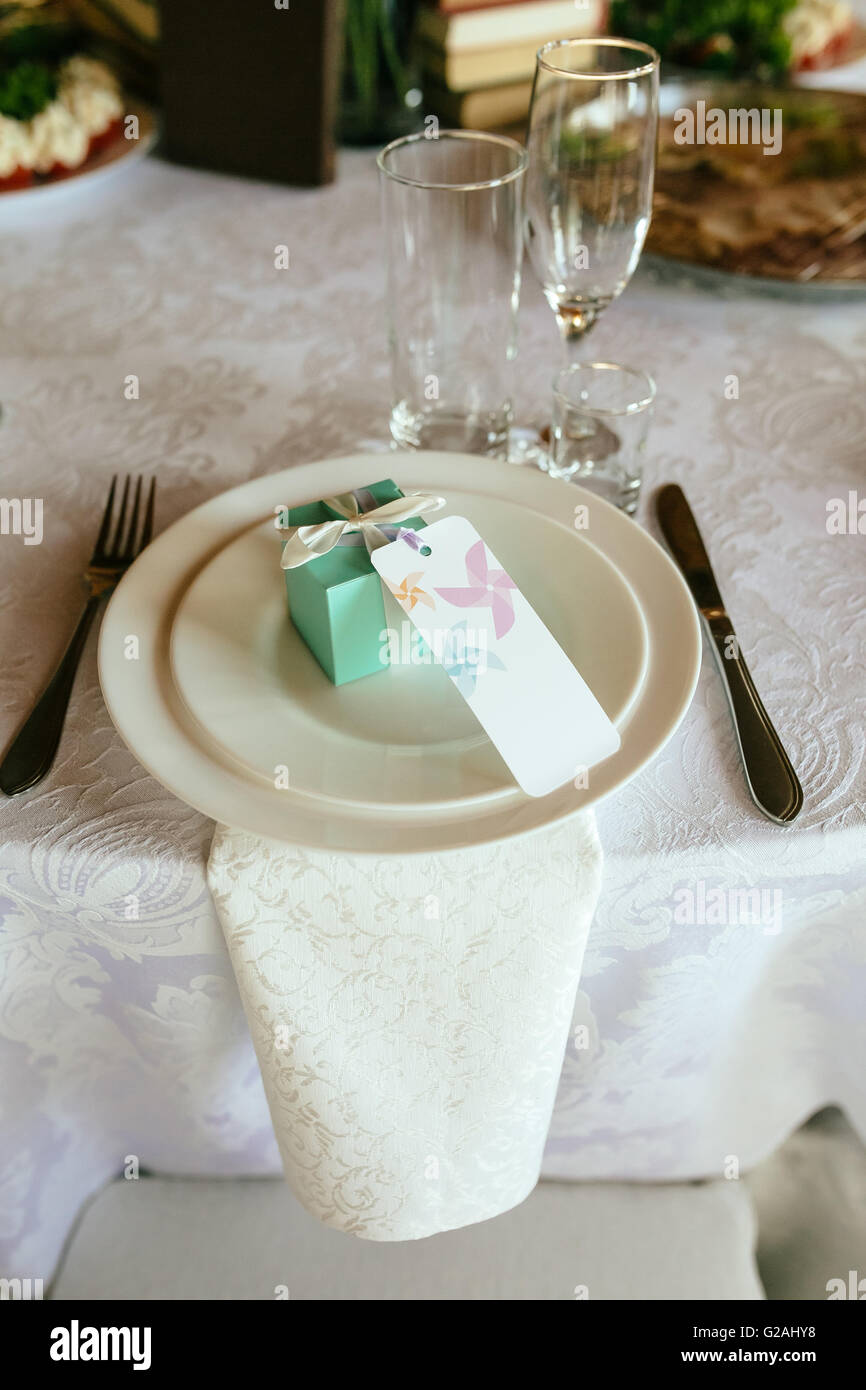 Table served with cutlery. on a plate and gift guest nameplate Stock ...