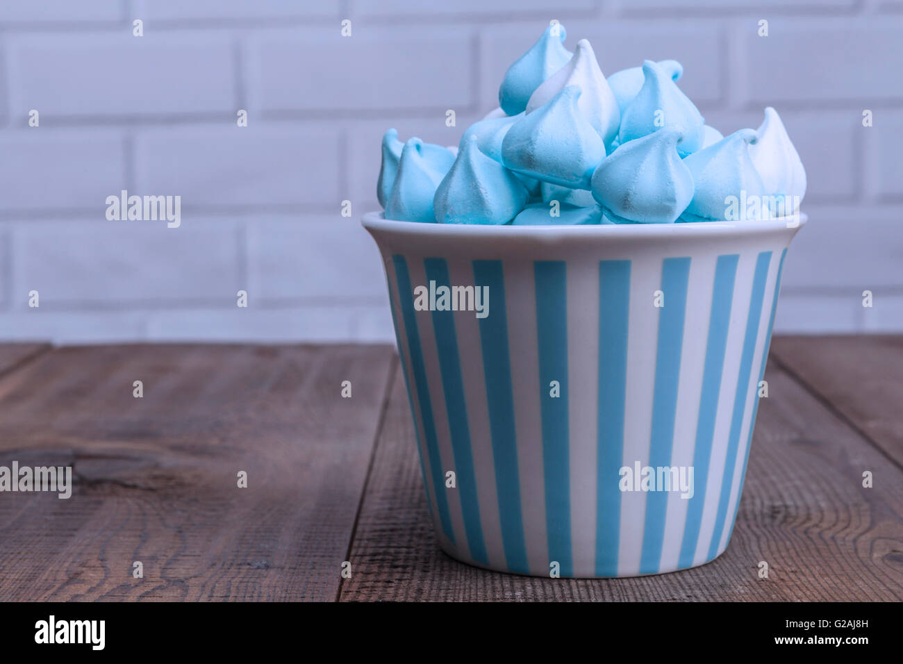 Blue sweets in a cup on wood table Stock Photo - Alamy