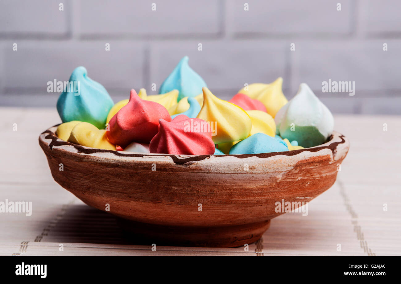 Tasty sweets on plate and brick background Stock Photo - Alamy