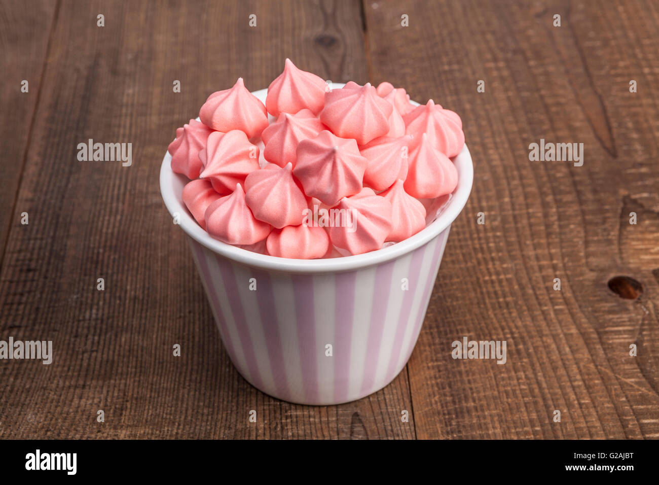 Pink sweets in a cup on wood table Stock Photo - Alamy