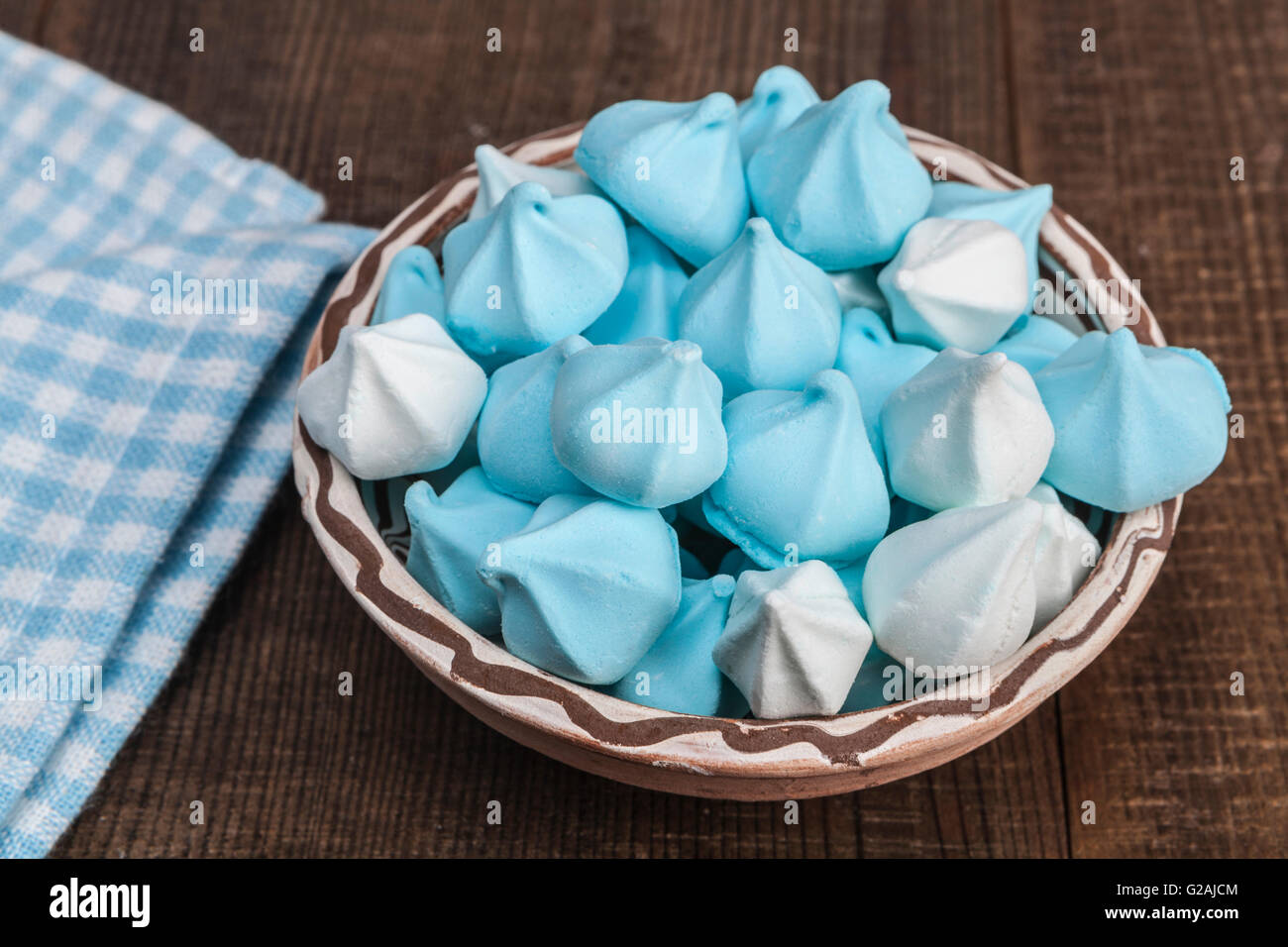 Blue Sweets on plate on brown wood table Stock Photo - Alamy