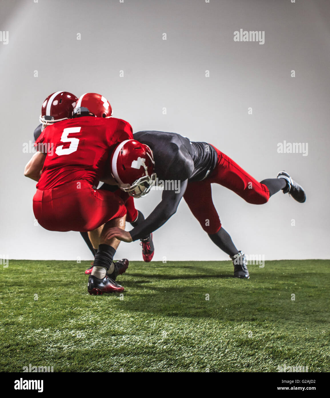 The three american football players in action Stock Photo - Alamy