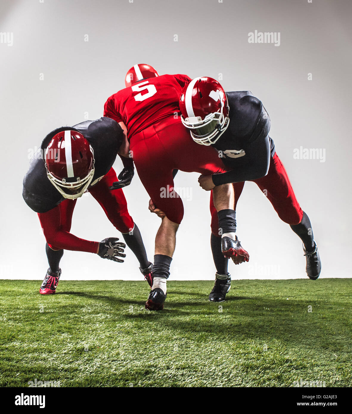The three american football players in action Stock Photo - Alamy