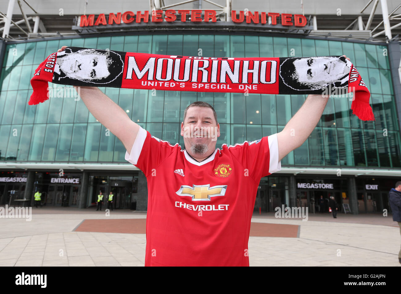 Manchester United fan John Bartrum holds up a Jose Mourinho scarf ...