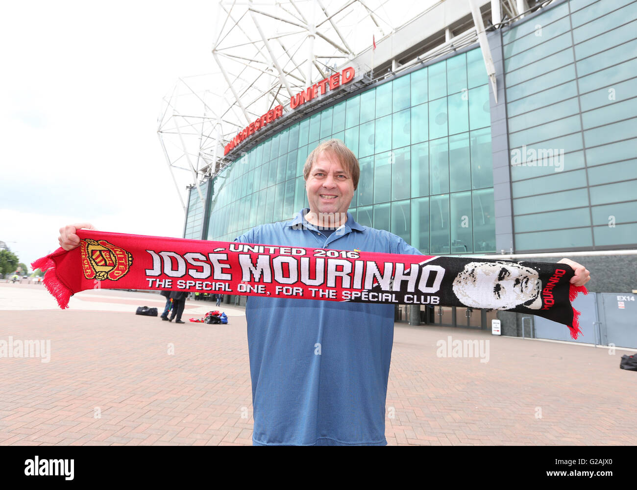 Manchester United fan Tim Brooks-Parry holds up a Jose Mourinho scarf ...