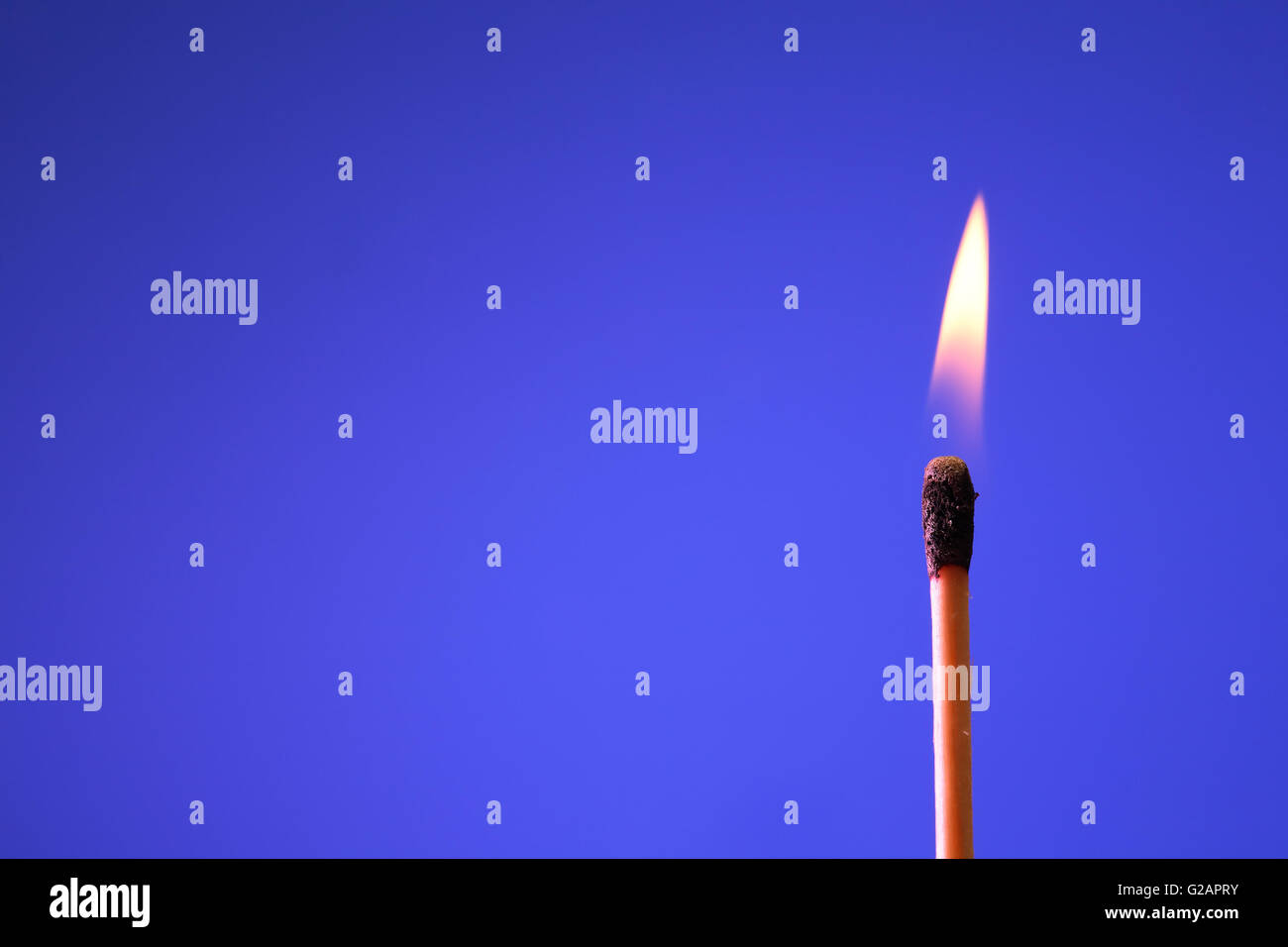 Lighting matchstick on blue background with free space for text Stock ...