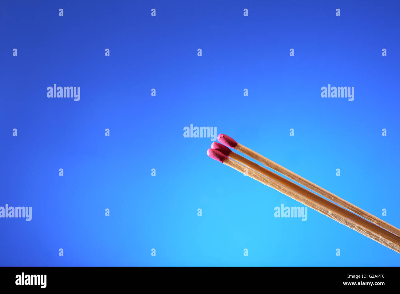 Three matchsticks on blue background with free space for text Stock ...