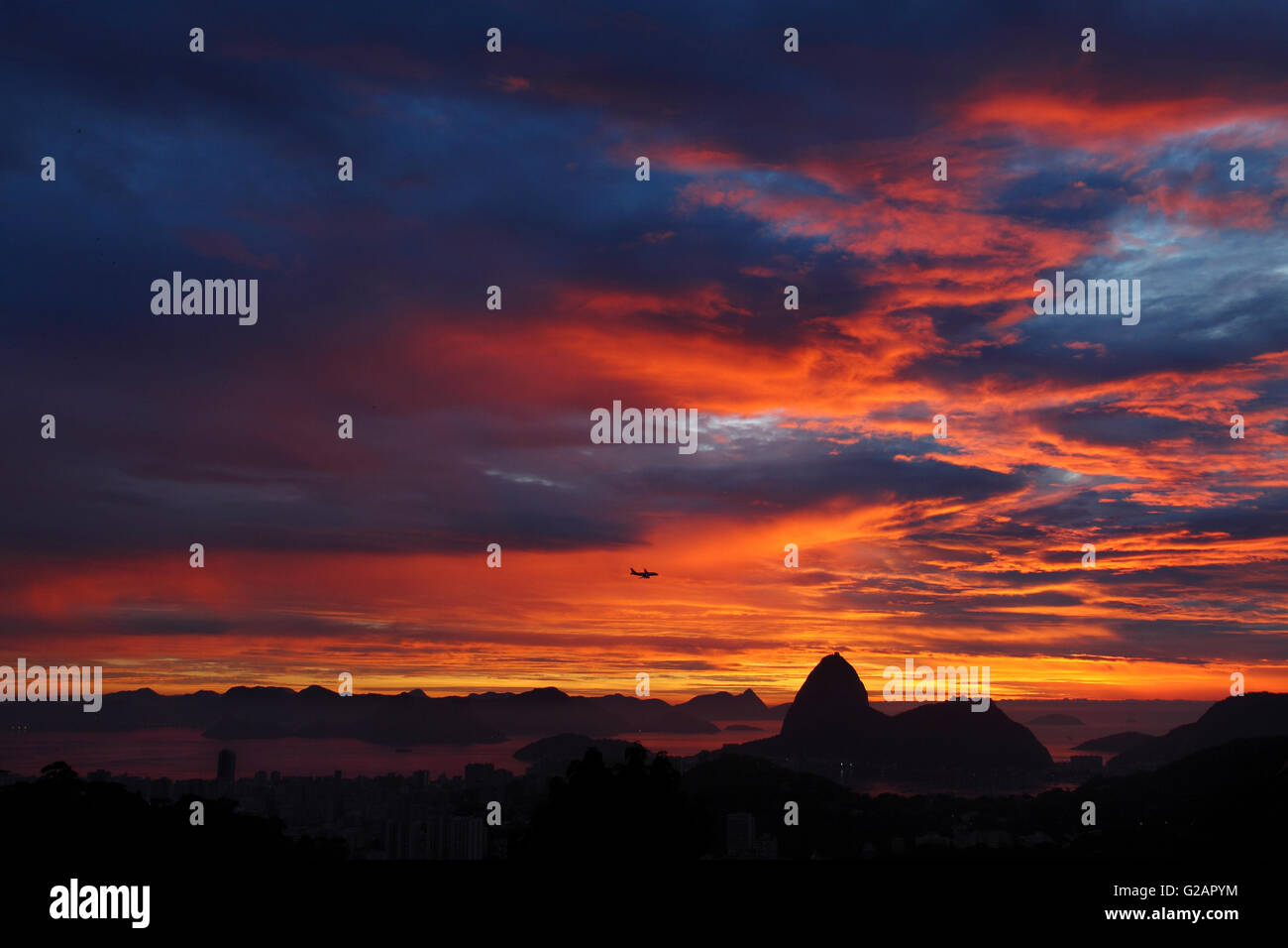 Airplane flies over Rio de Janeiro city at sunrise, Sugar loaf mountain ...