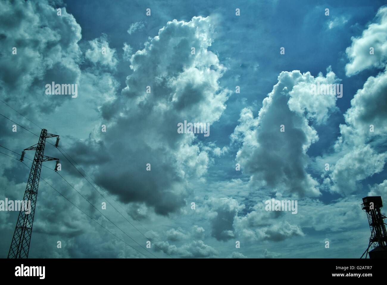 Dark clouds above electricity pylons Stock Photo - Alamy