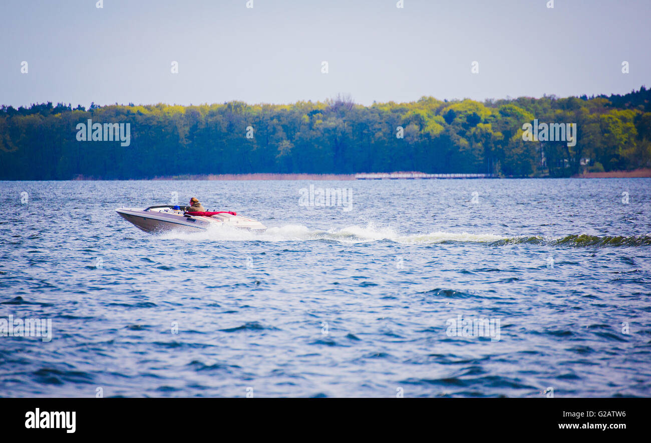 Speed motor boat on a azure lake Stock Photo - Alamy