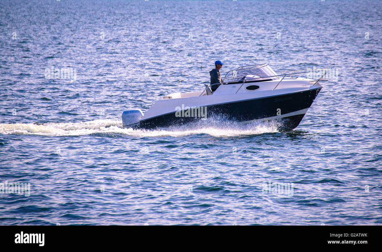 Speed motor boat on a azure lake Stock Photo - Alamy