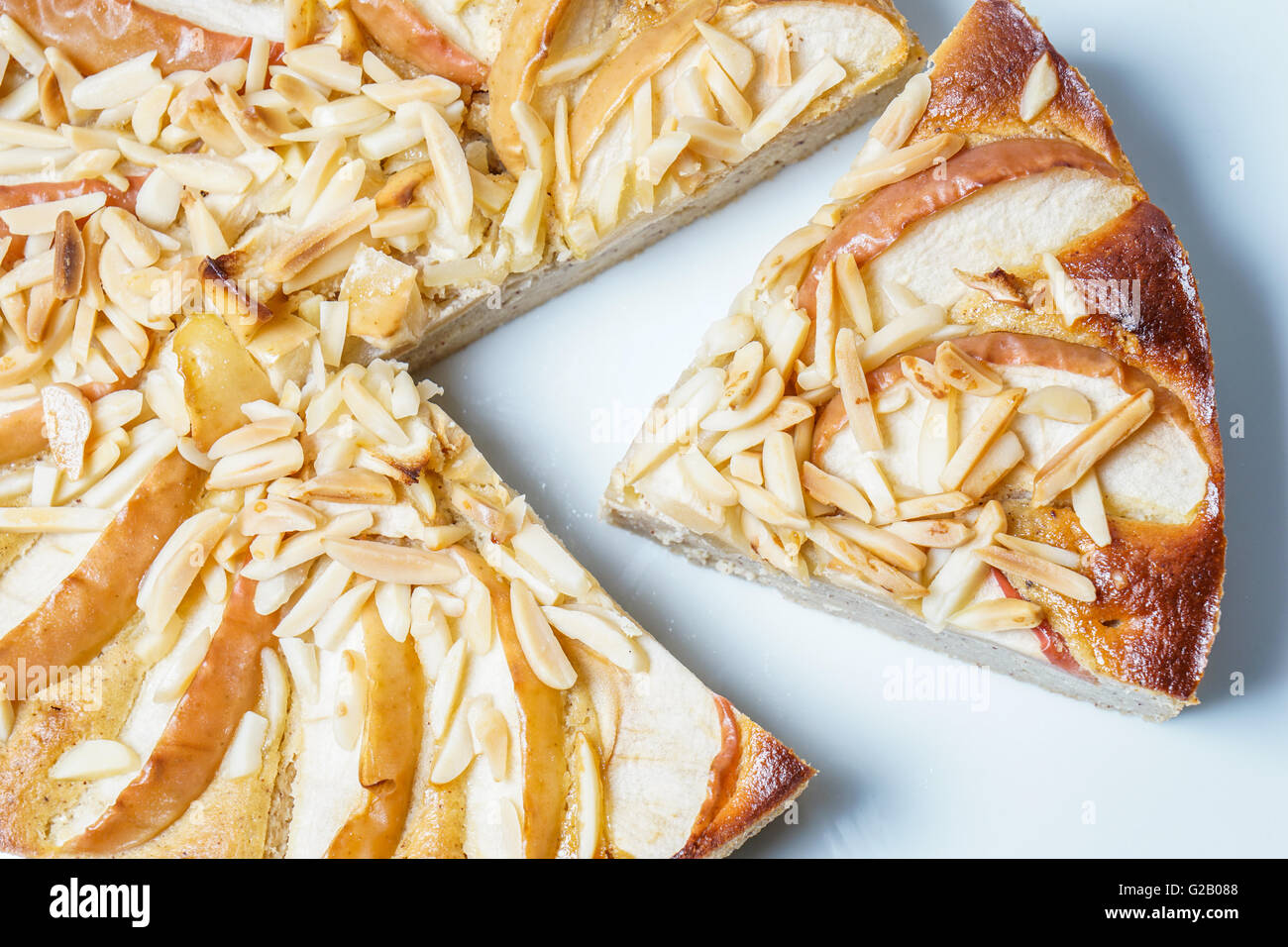 Apple pie with almonds served on a white plate Stock Photo - Alamy