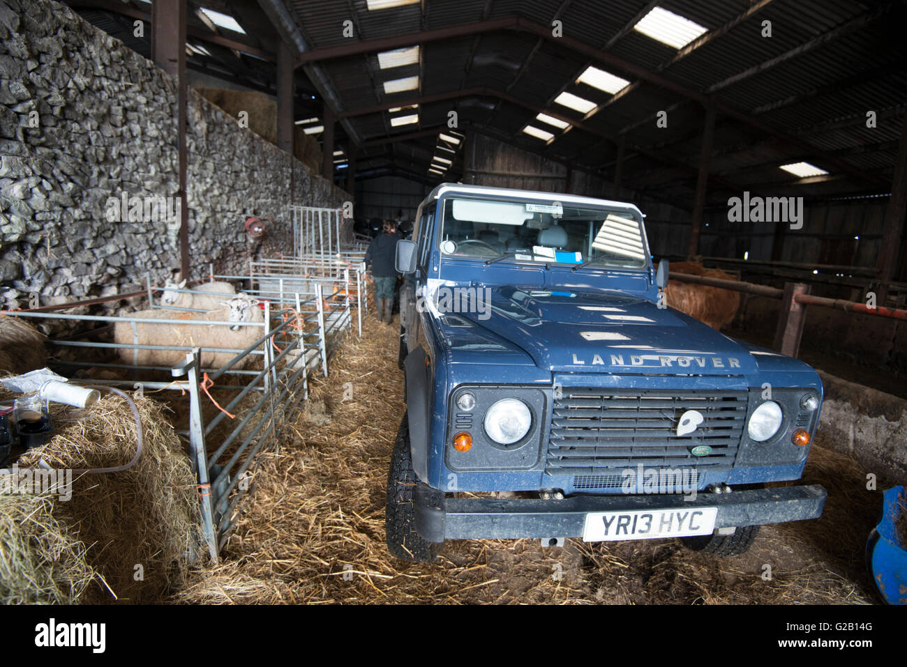 A blue Land Rover parked inside a barn on a farm in Derbyshire England ...