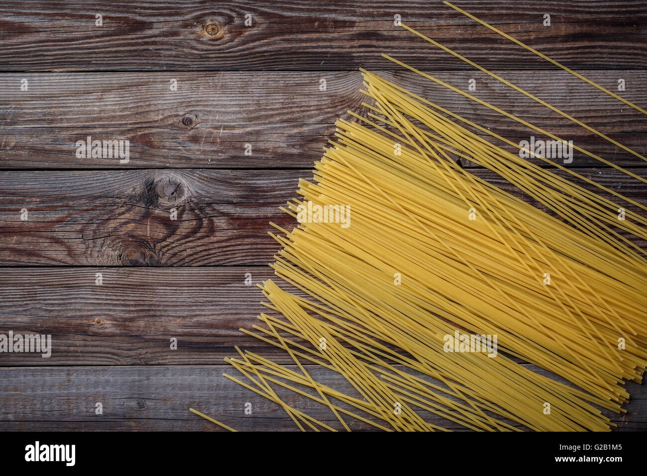 Yellow long spaghetti on black background. Raw spaghetti Stock Photo ...