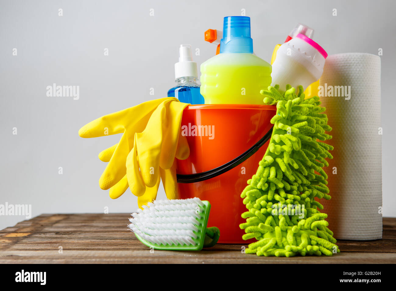 Bucket with cleaning items on light background Stock Photo - Alamy